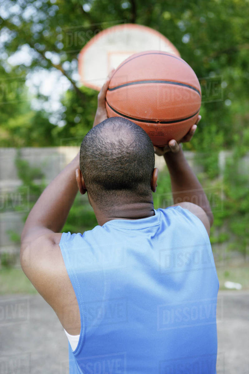 Man shooting basketball - Stock Photo - Dissolve