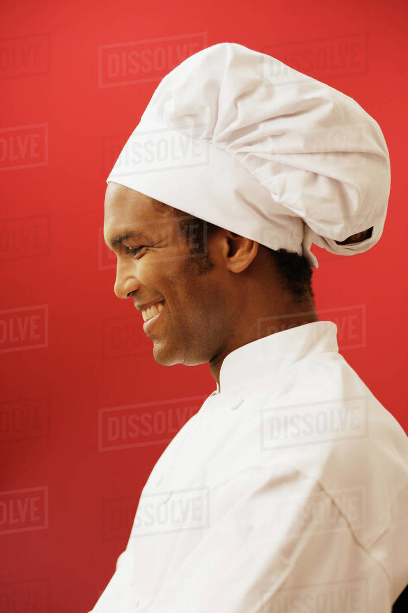 Side view of male chef wearing hat - Royalty-free Stock Photo | Dissolve