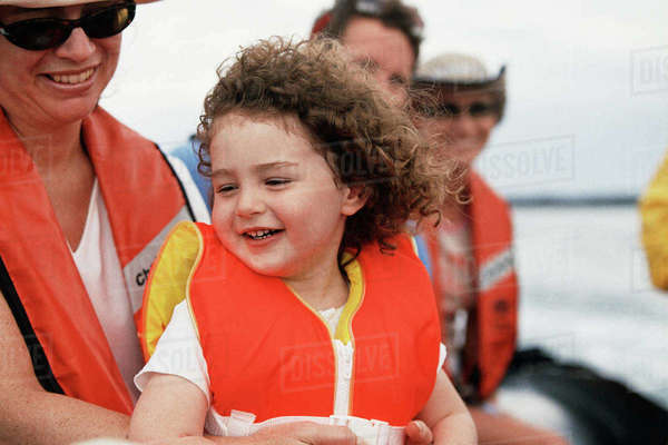 Mother and young daughter wearing life-jackets on boat - Stock Photo ...