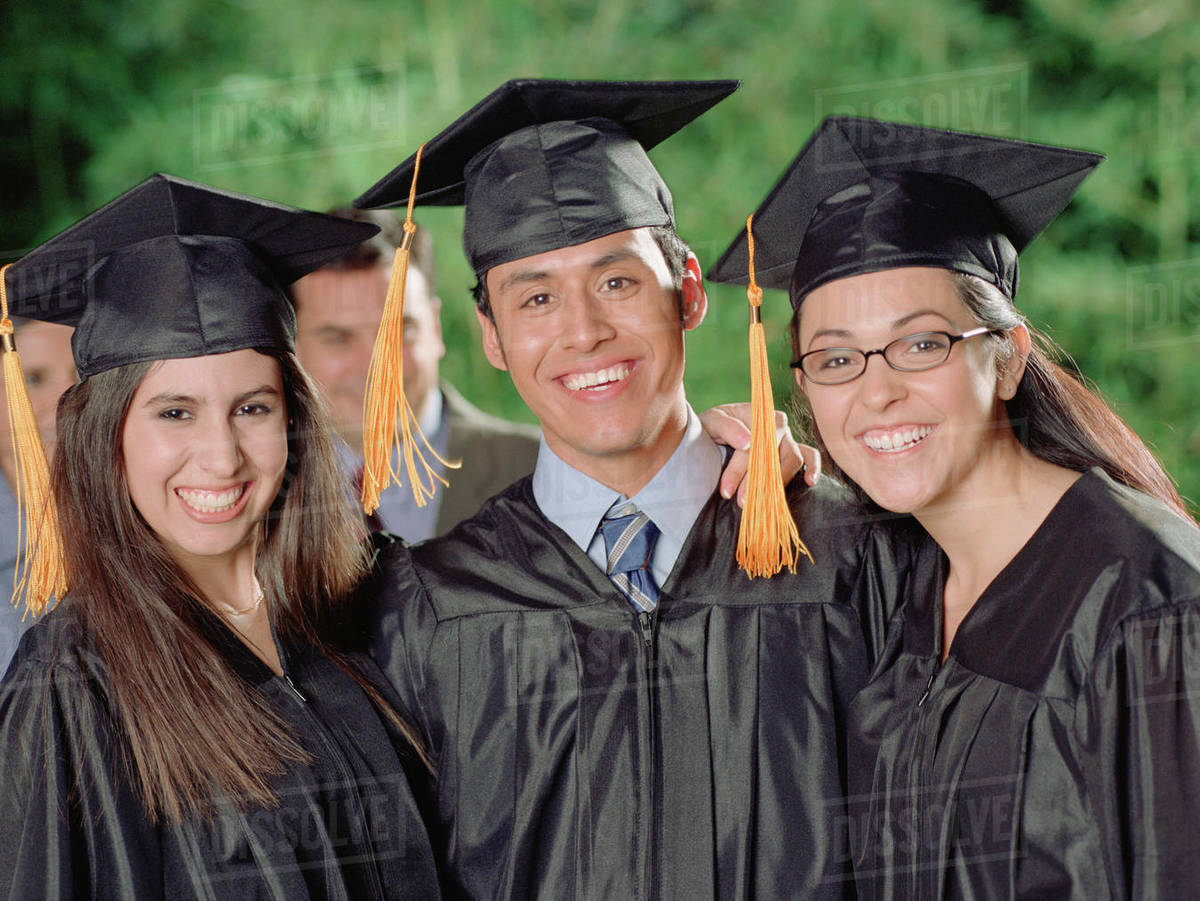 Graduates smiling for the camera - Stock Photo - Dissolve
