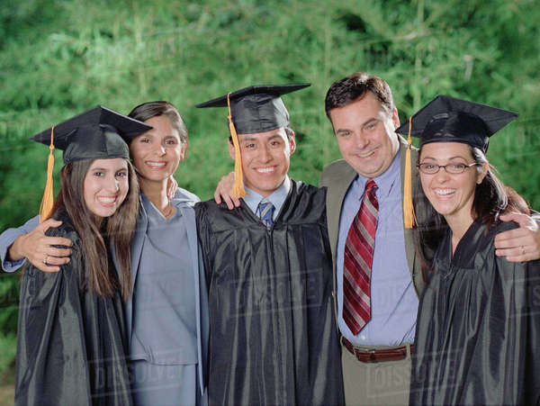 Graduates smiling for the camera with their parents - Royalty-free ...