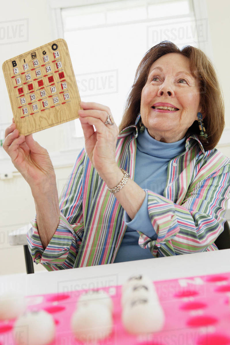 Elderly woman winning at bingo - Royalty-free Stock Photo | Dissolve