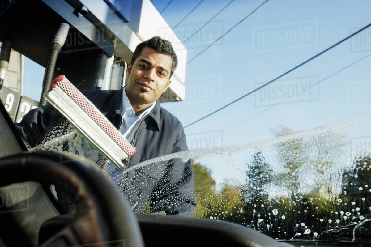 Man wiping car windshield - Stock Photo - Dissolve