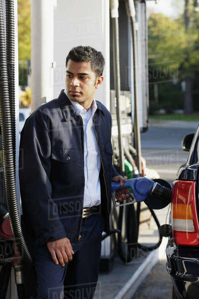 Young man pumping gas - Royalty-free Stock Photo | Dissolve