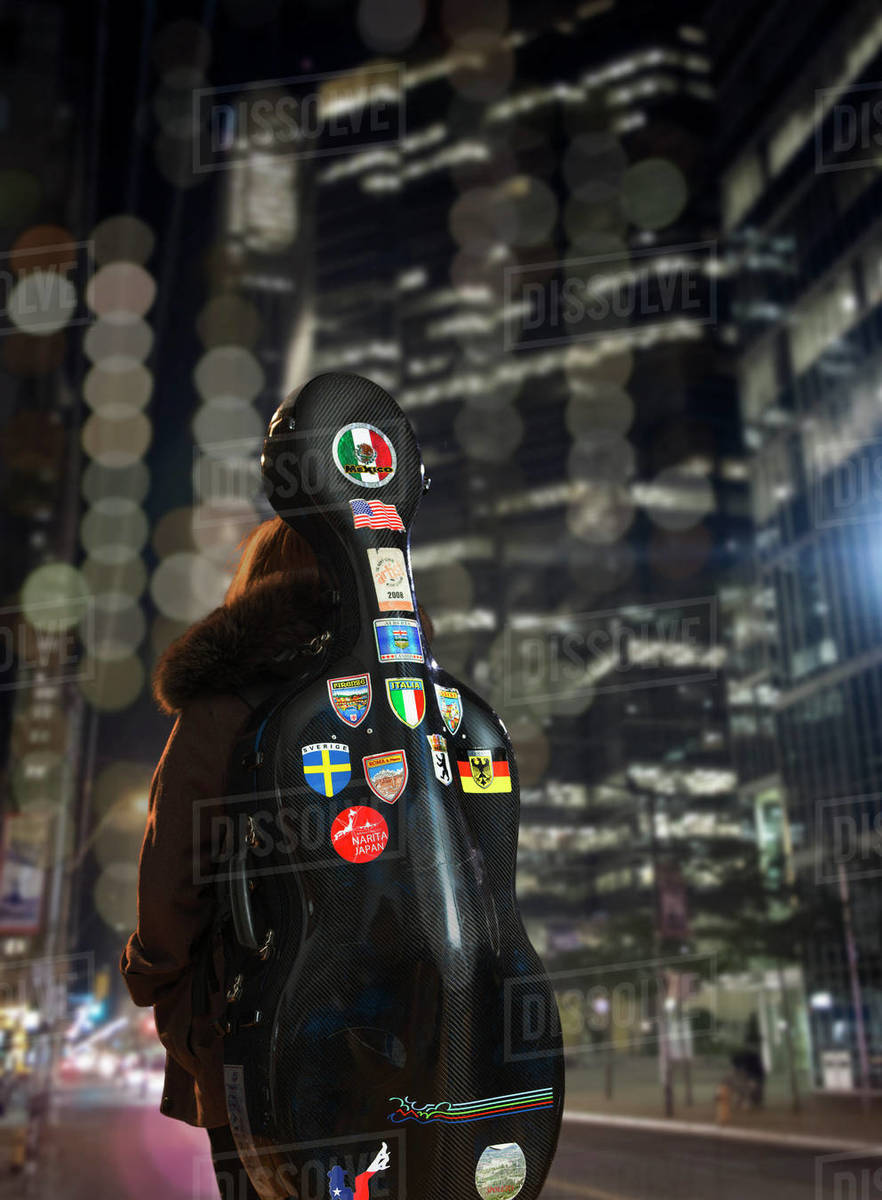 Musician carrying cello case in city - Royalty-free Stock Photo | Dissolve