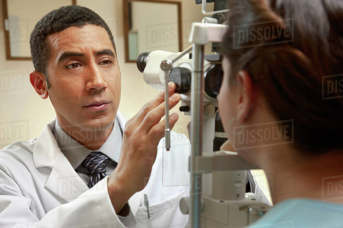 Optician examining patient's vision - Royalty-free Stock Photo | Dissolve