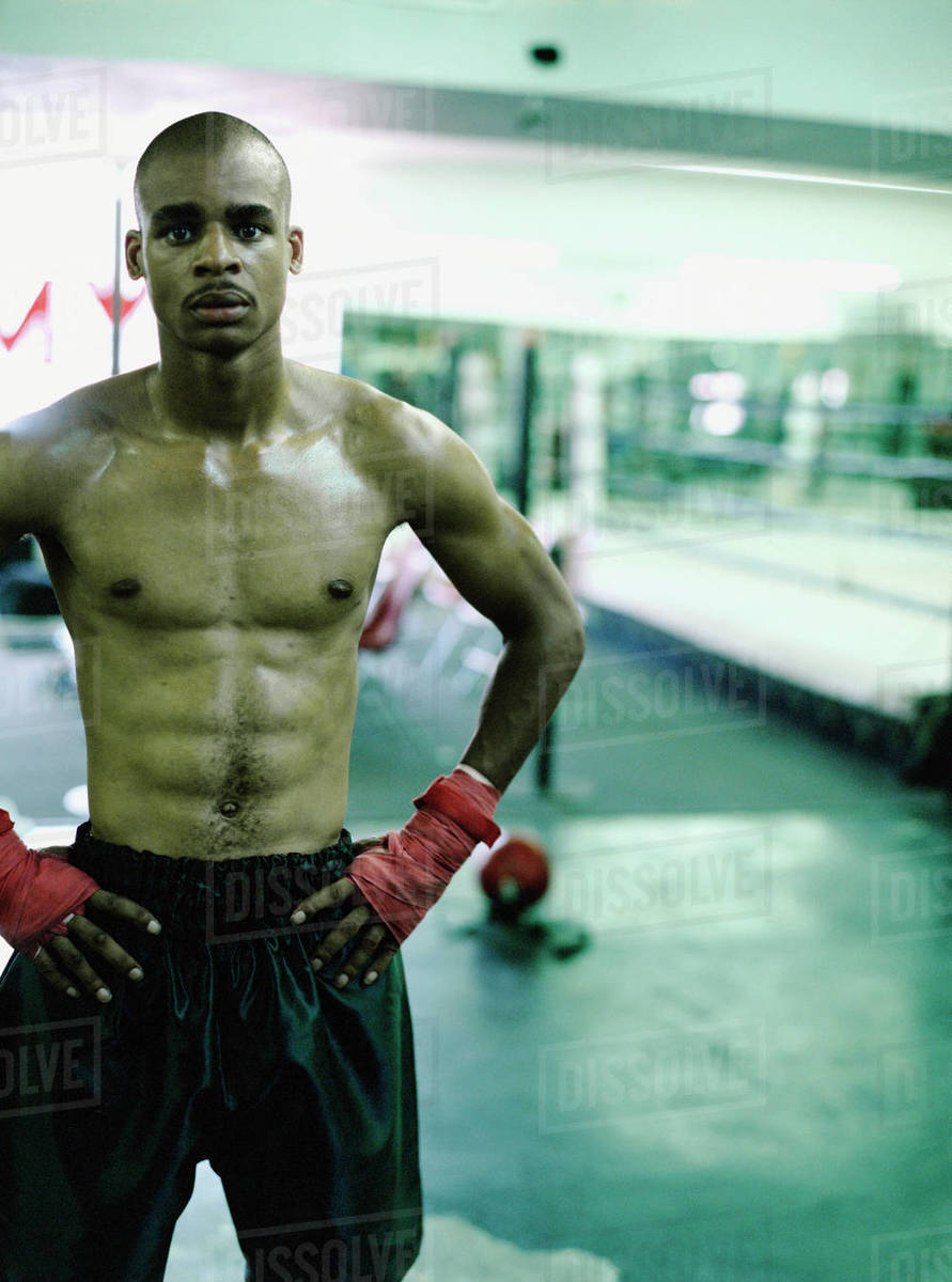 African boxer standing in gymnasium - Stock Photo - Dissolve