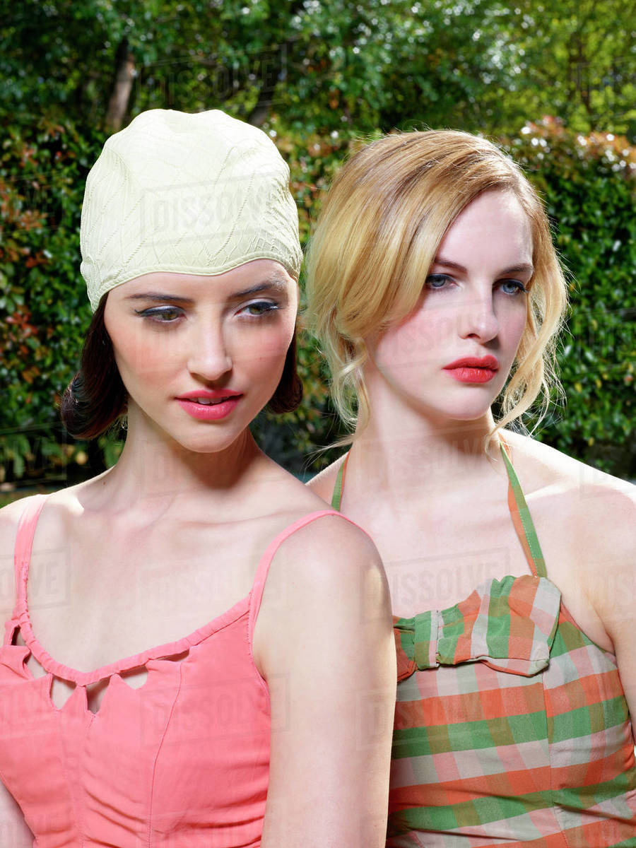 Closeup portrait of two women in vintage style bathing suits, sitting ...