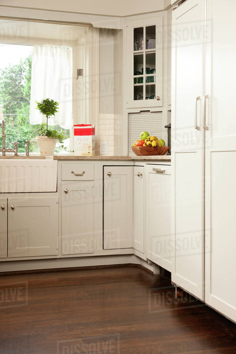Low angle view of kitchen counter and hardwood floors - Stock Photo ...