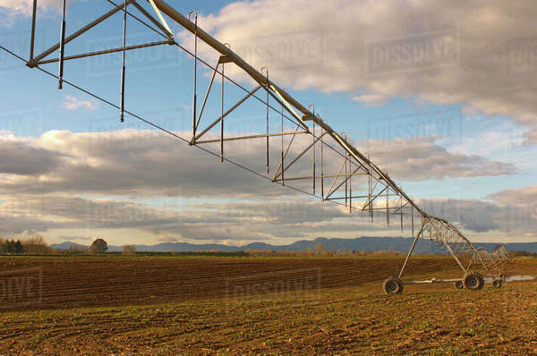 Moveable Irrigation boom sprinkler system in large ploughed field ...