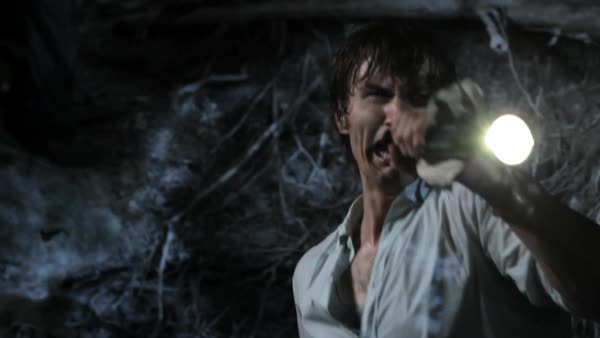 Man holding flashlight in woods at night screaming and shaking in fear ...