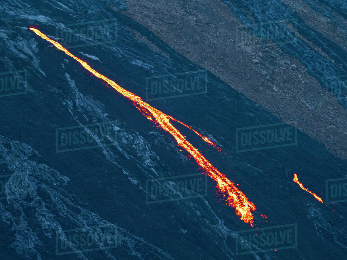 Glowing Lava cascade spilling from lava tube from Fagradalsfjall ...