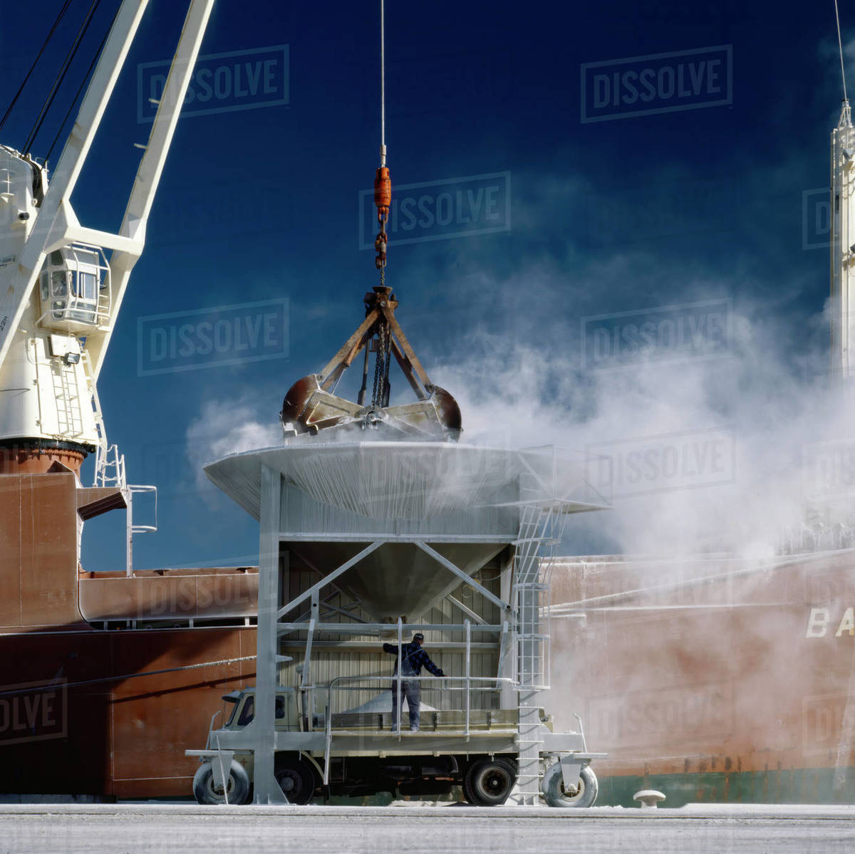Unloading salt into hopper at the wharf from supply ship - Royalty-free ...