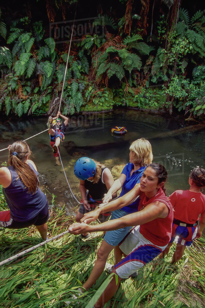 Team building using ropes to cross river - Royalty-free Stock Photo ...