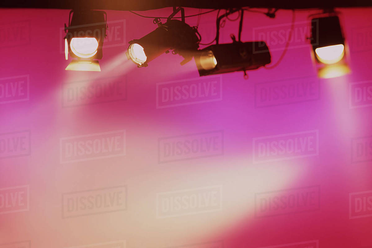 Stage lights shining golden light with pink background - Royalty-free ...