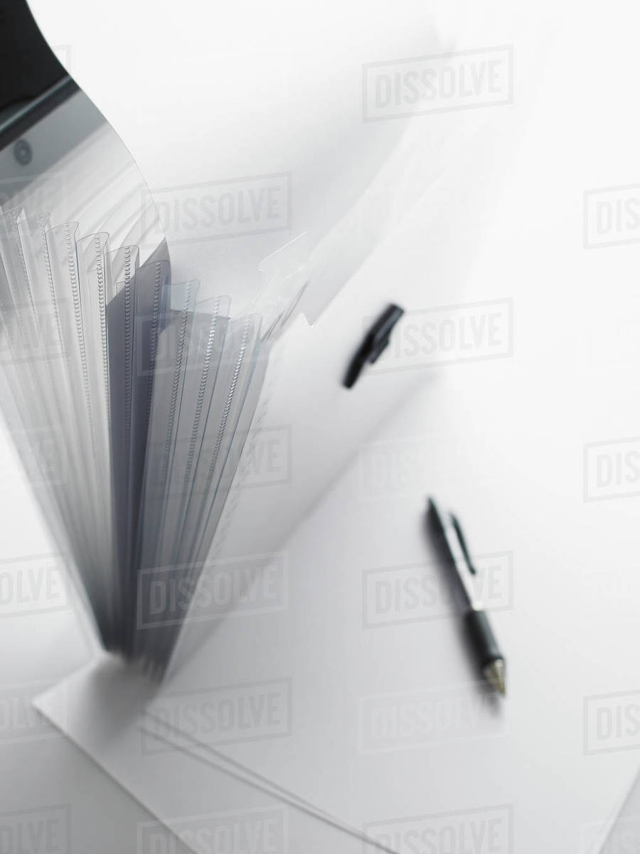 Clear plastic expanding concertina file and pen on desk - Royalty-free ...
