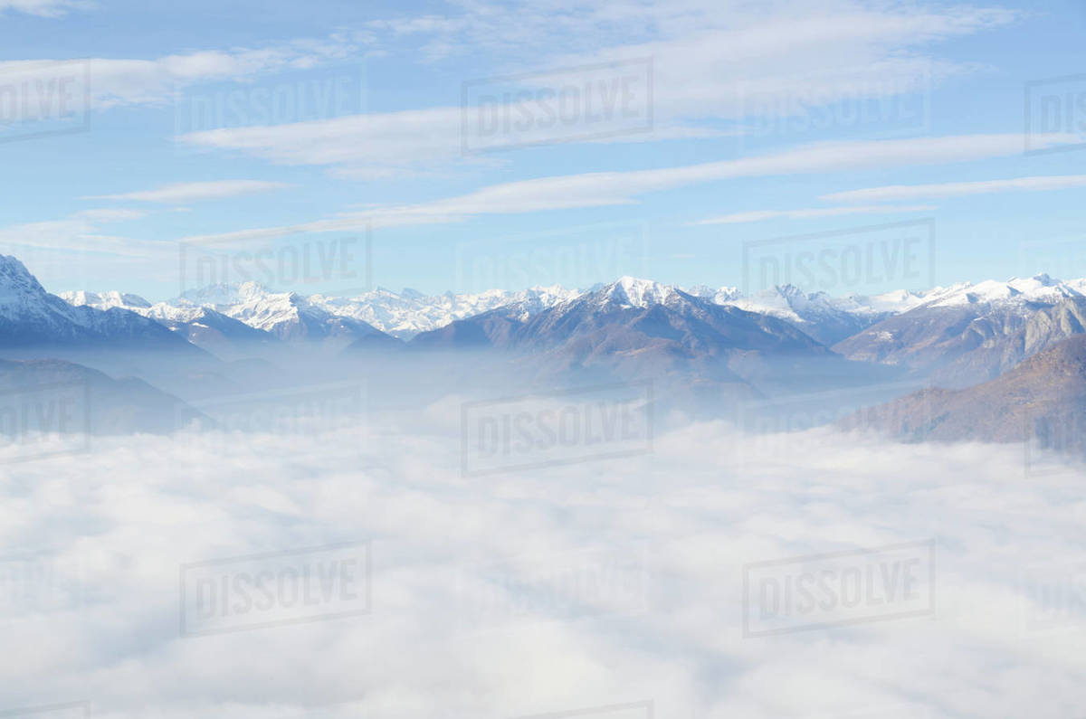 Aerial View over Snow-capped Mountain Above Cloudscape in a Sunny Day ...