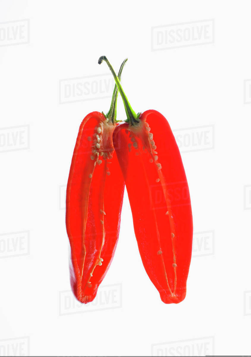 Close up of long red chilli cut in half on clear background - Stock ...