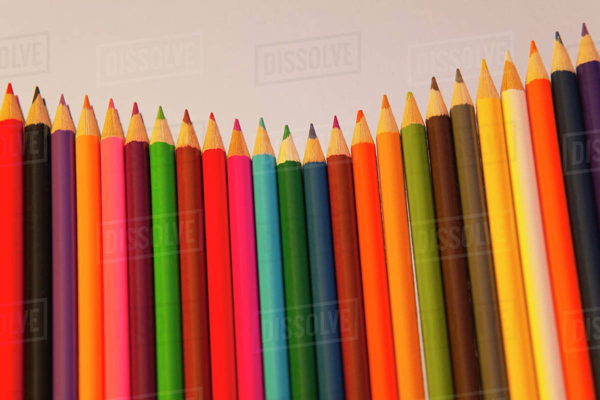 Row of colored pencils with sharp points - Stock Photo - Dissolve