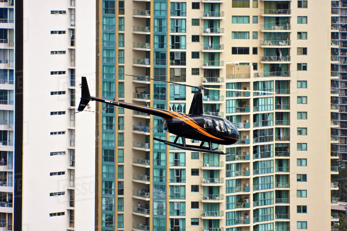 Helicopter over buildings - Stock Photo - Dissolve