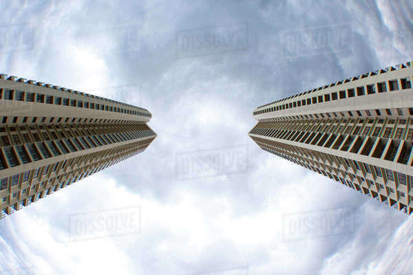 Two skyscrapers under cloudy sky - Stock Photo - Dissolve