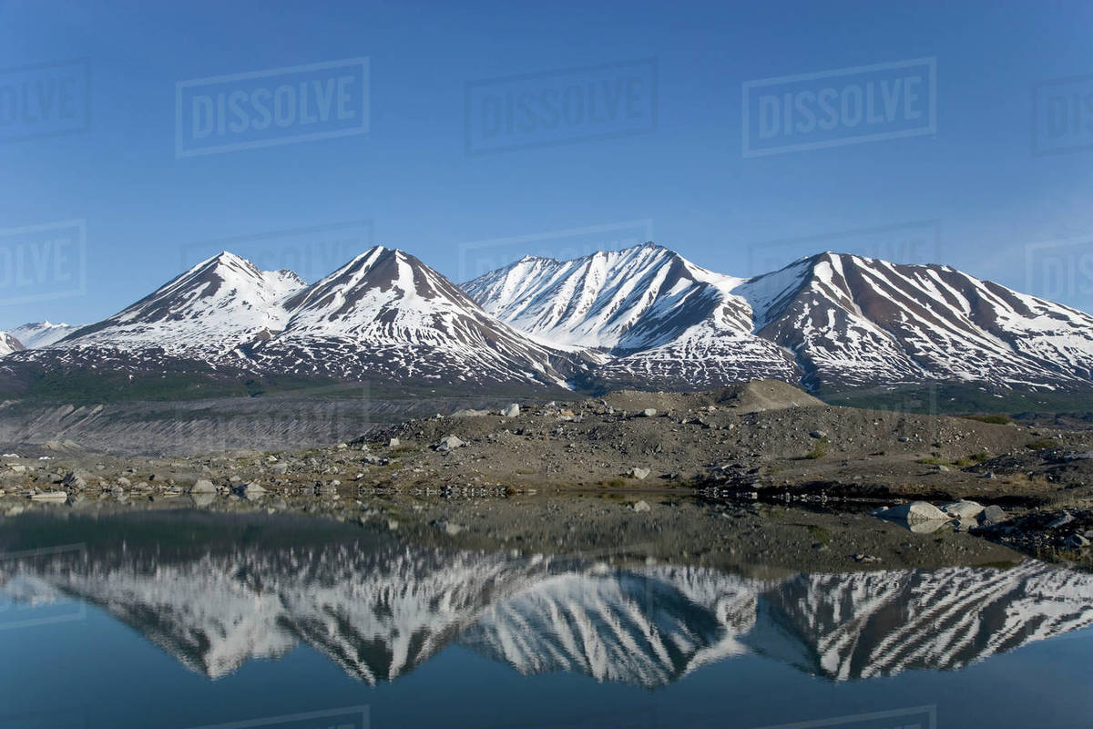 Reflection of mountains in water, Alsek River Valley, British Columbia ...