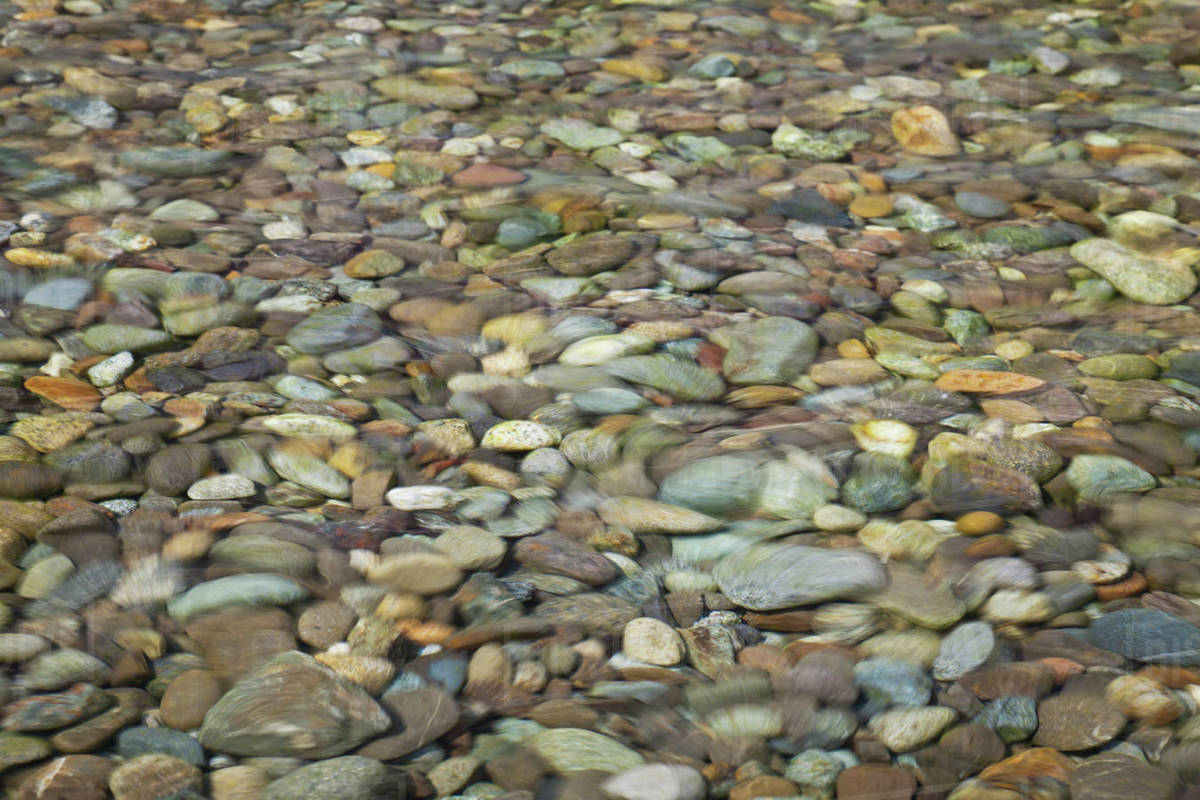 Pebbles under water, high angle view - Royalty-free Stock Photo | Dissolve