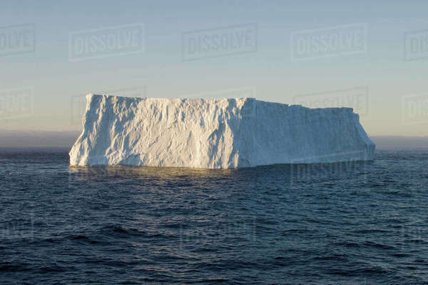 Iceberg floating on water - Stock Photo - Dissolve
