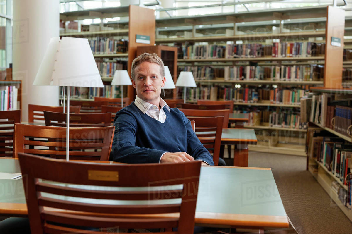 Portrait of happy school teacher in library at school - Royalty-free ...