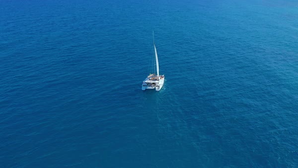 Catamaran sailing on the sea. Aerial shoot of the Catamaran sailing in ...