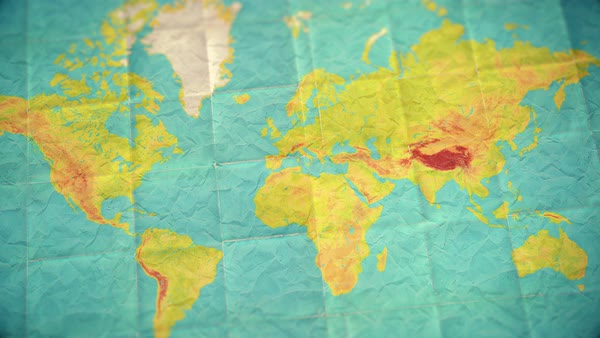Zoom in from World Map to Europe. Old well used world map with crumpled ...