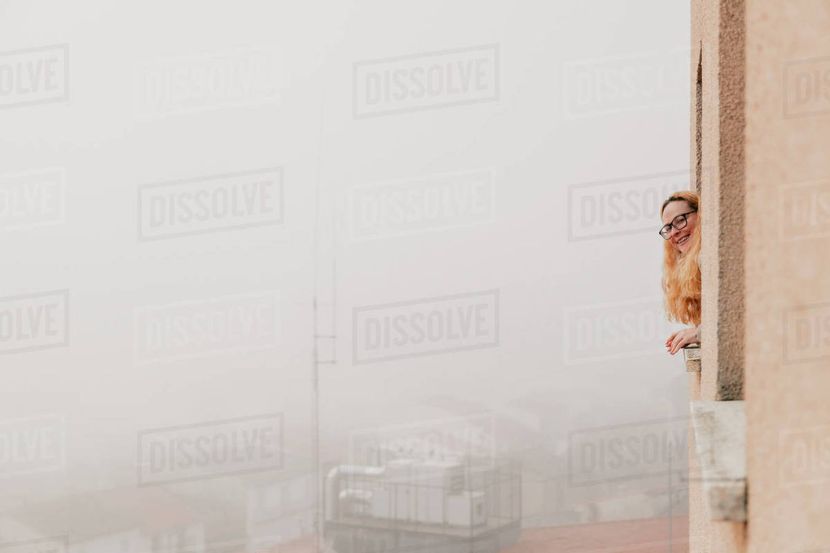 Quarantined woman bending over the window watching outside - Royalty ...