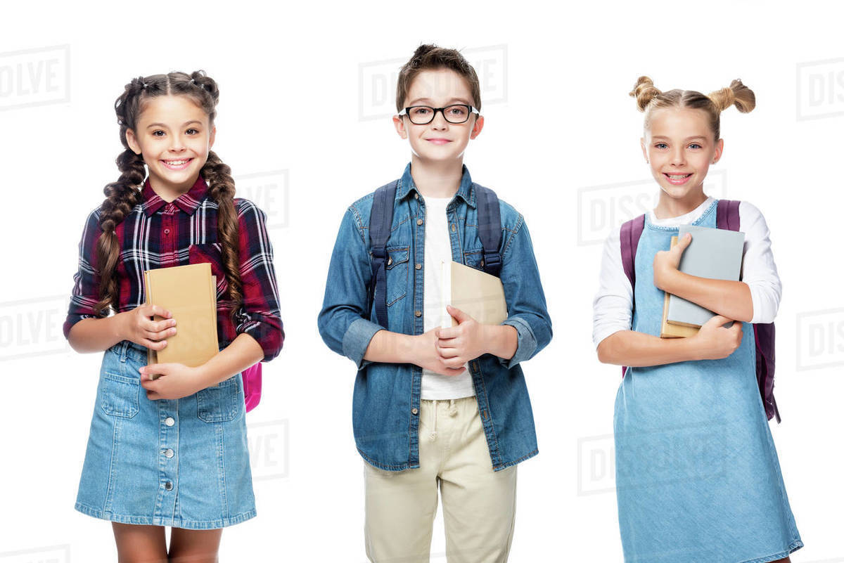 three smiling classmates holding books and looking at camera isolated ...