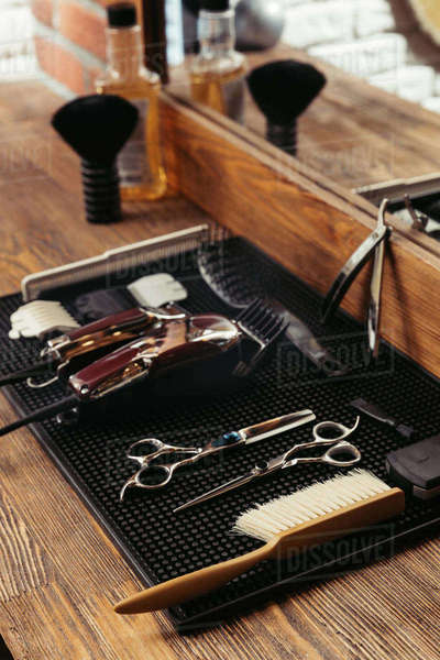 Set of various professional barber tools and mirror in barbershop ...