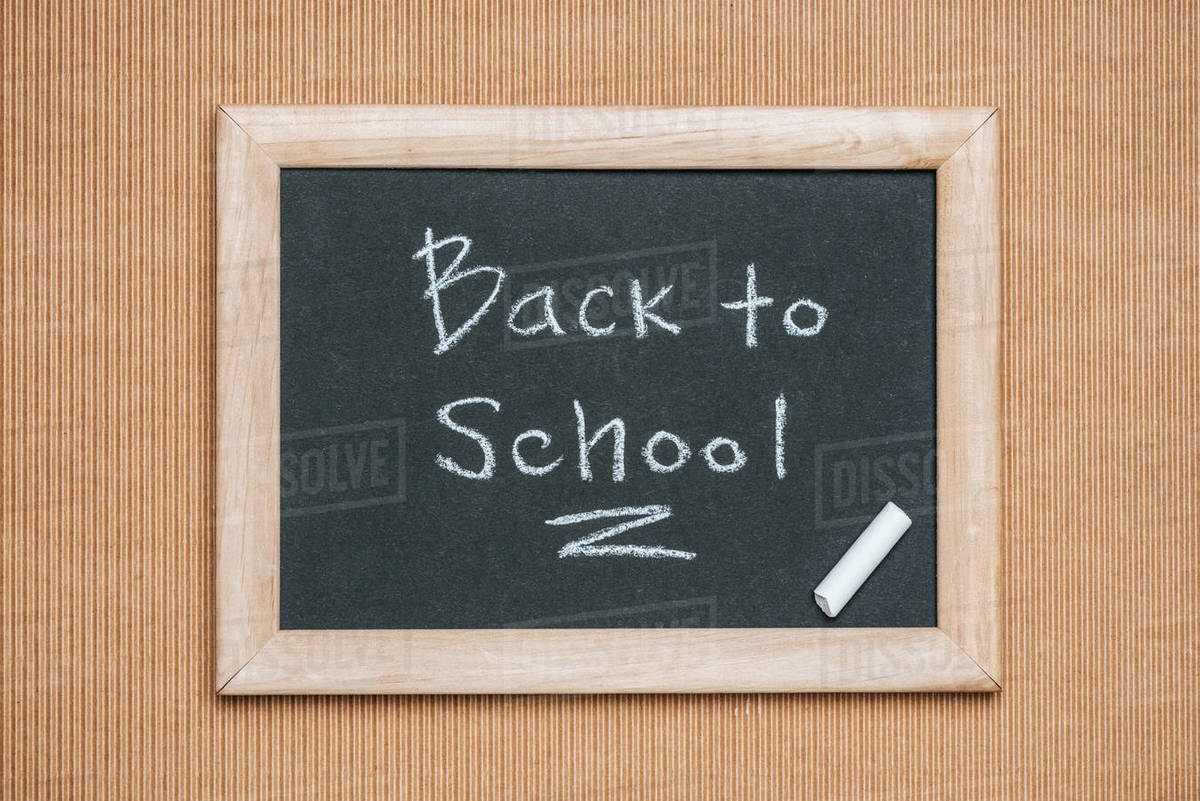Top view of blackboard with back to school inscription and piece of ...