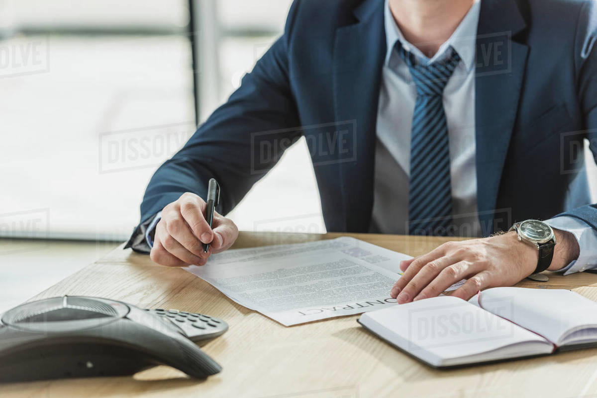 Cropped shot of businessman signing contract at workplace - Royalty ...