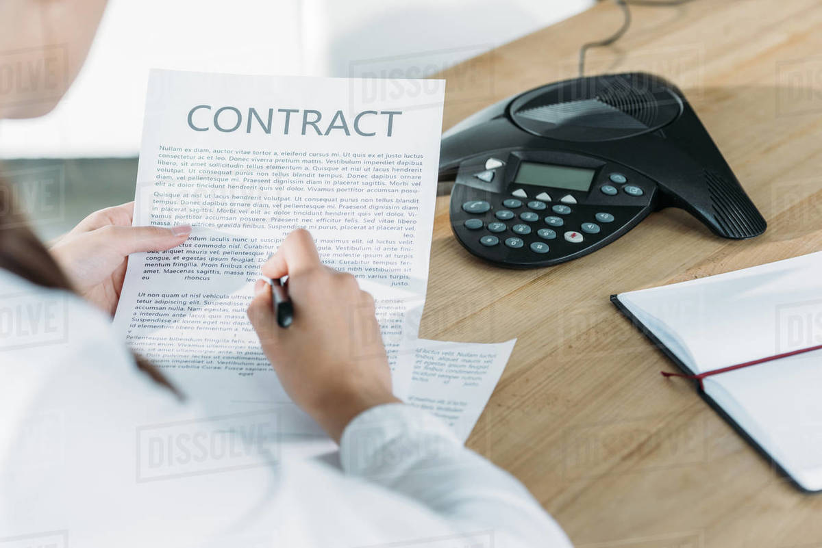 Cropped shot of businesswoman reading contract at office - Royalty-free ...