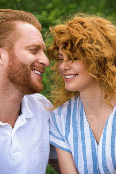 Portrait of happy redhead couple with closed eyes outdoors - Royalty ...