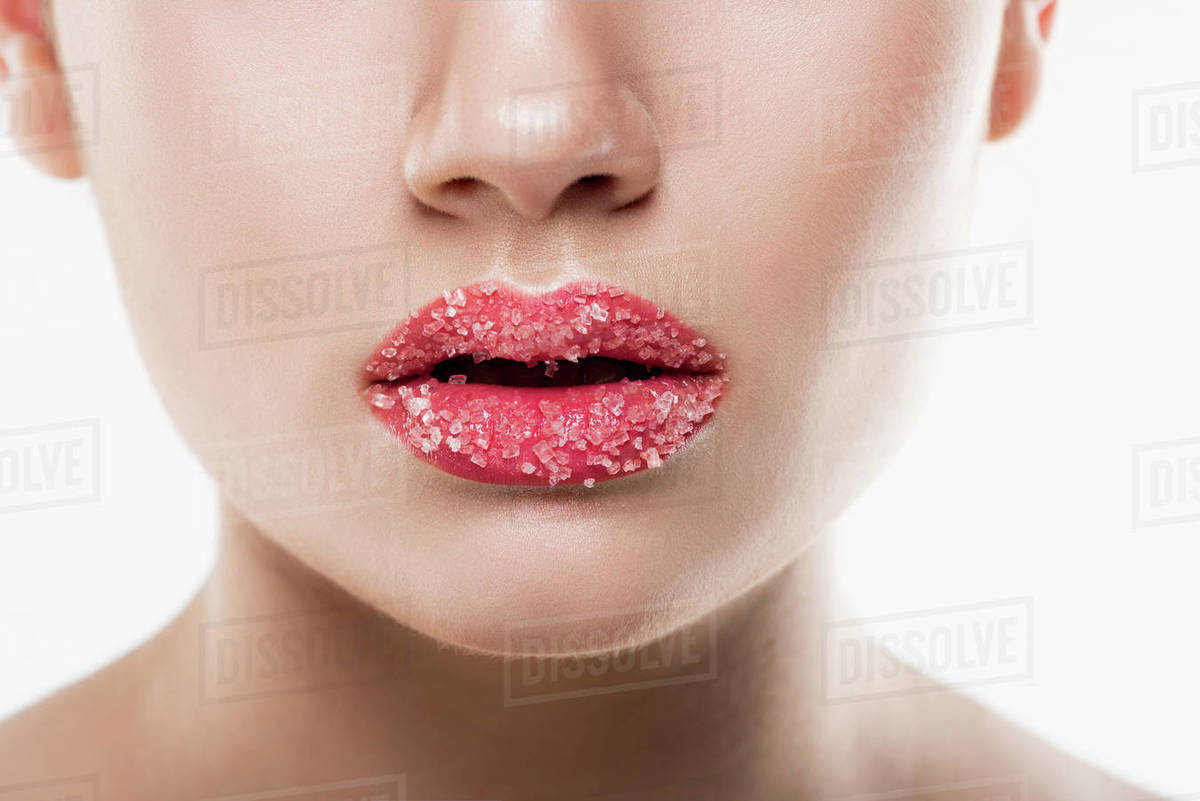 Partial view of girl with sweet sugar on lips, isolated on white ...