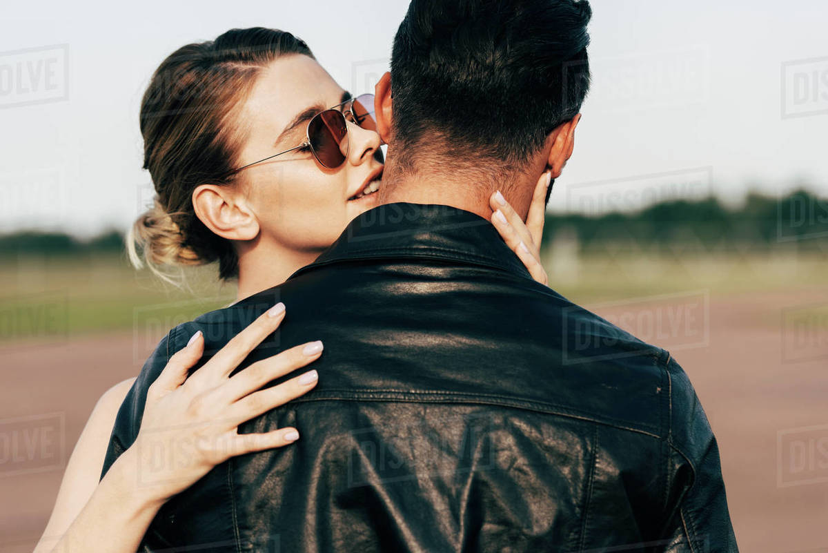 Selective focus of beautiful smiling woman embracing boyfriend in ...