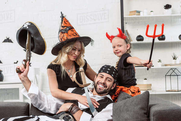 Portrait of family in halloween costumes at home - Stock Photo - Dissolve