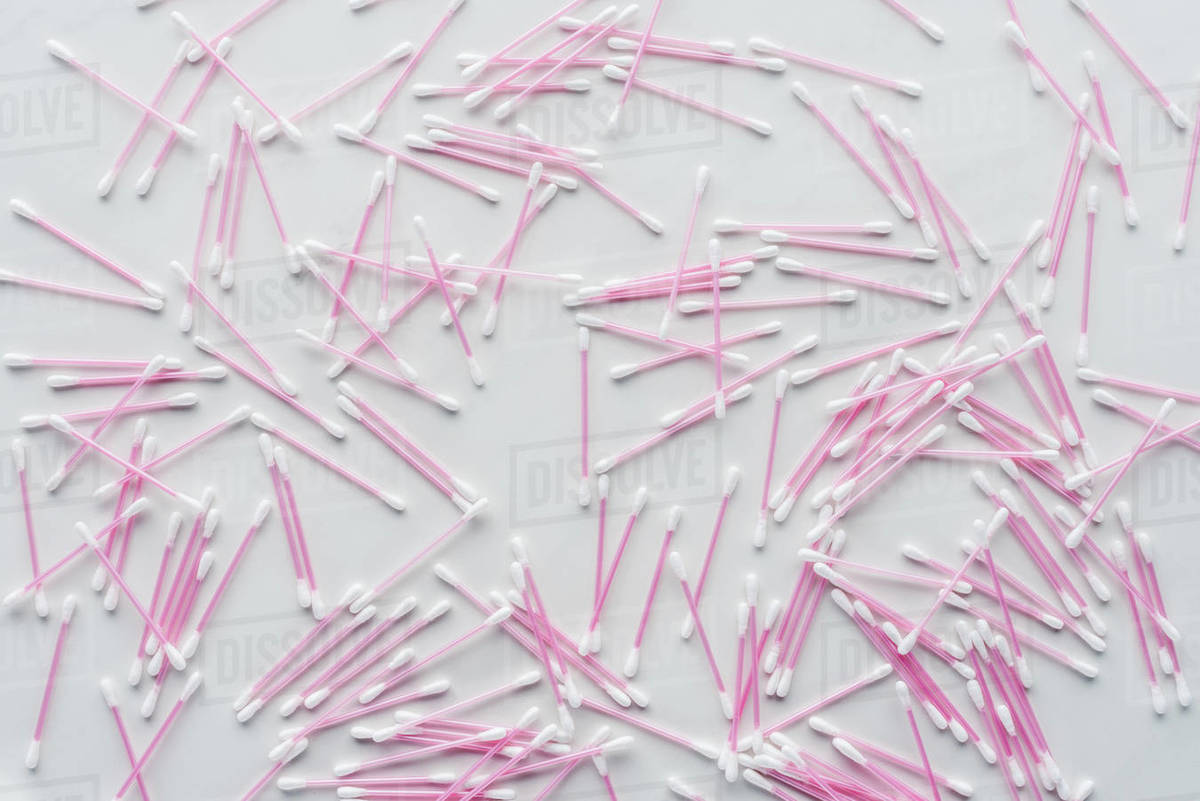 Top view of scattered pink cotton swabs isolated on white, beauty ...