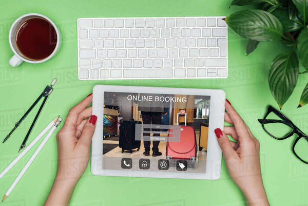 Cropped image of female architect holding digital tablet with online ...