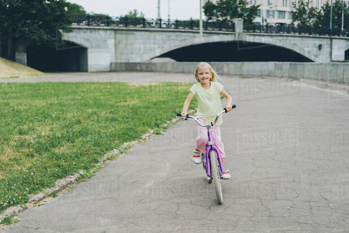 Happy child riding bicycle alone on street - Royalty-free Stock Photo ...