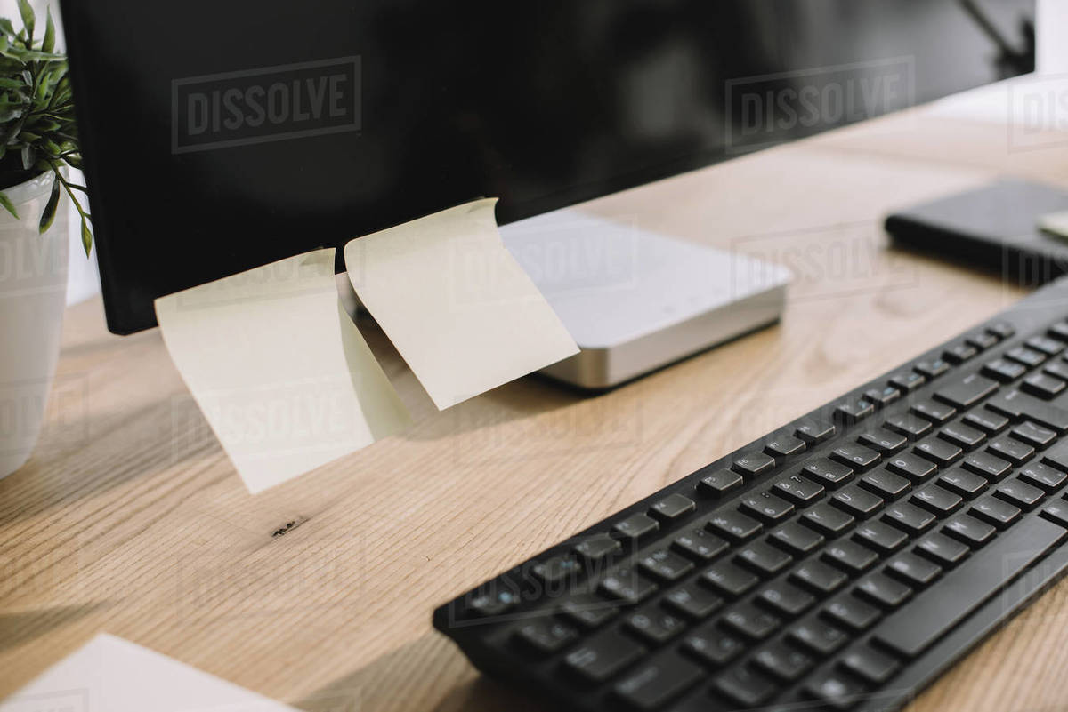 Close-up shot of computer screen with blank stickers and keyboard at ...