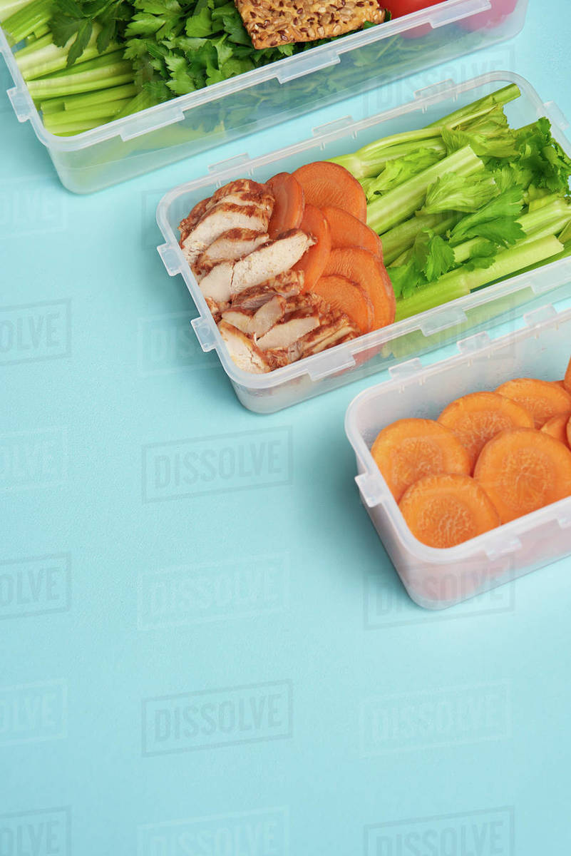 close up view of arrangement of food containers with fresh healthy ...