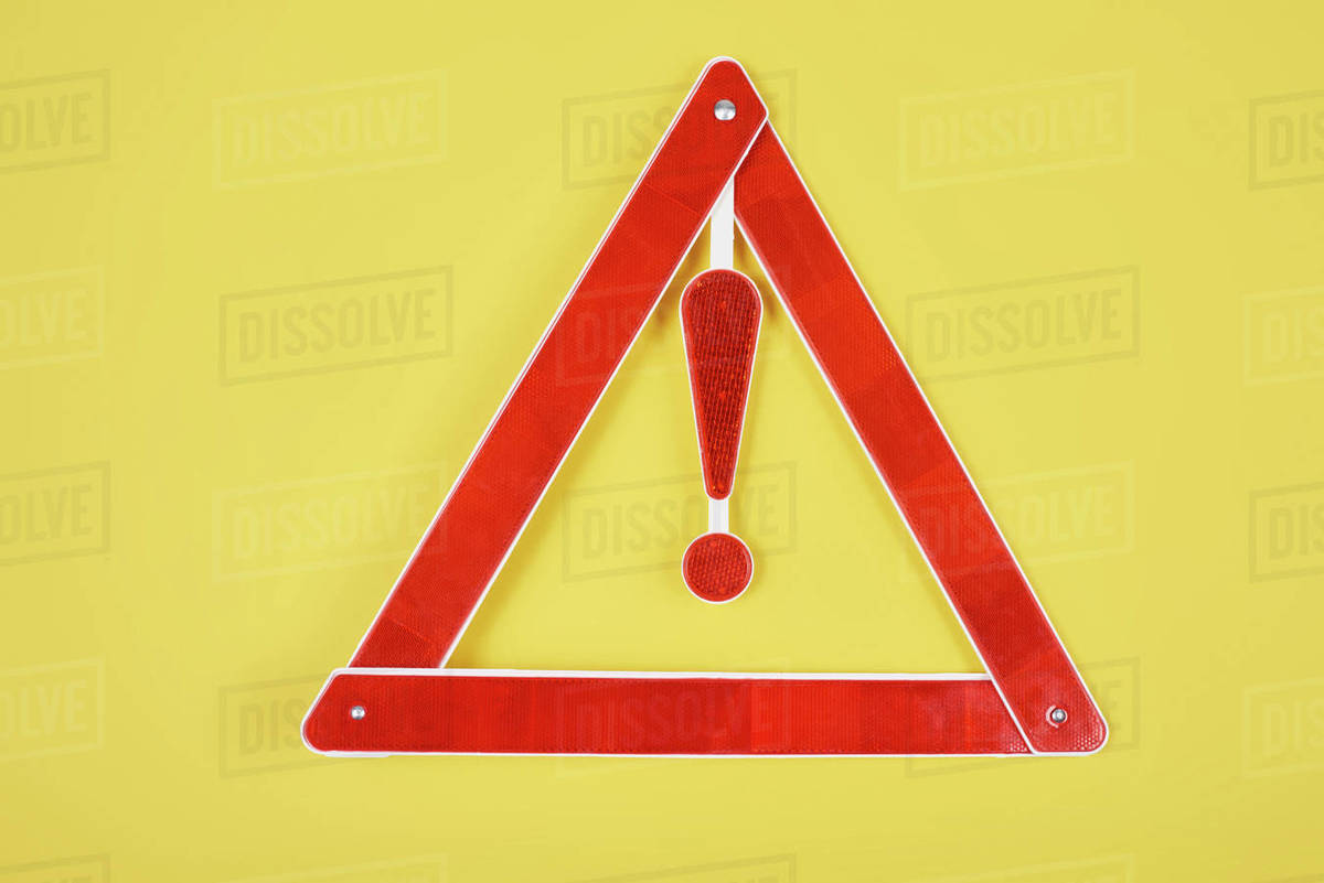 top view of warning triangle road sign isolated on yellow - Royalty ...