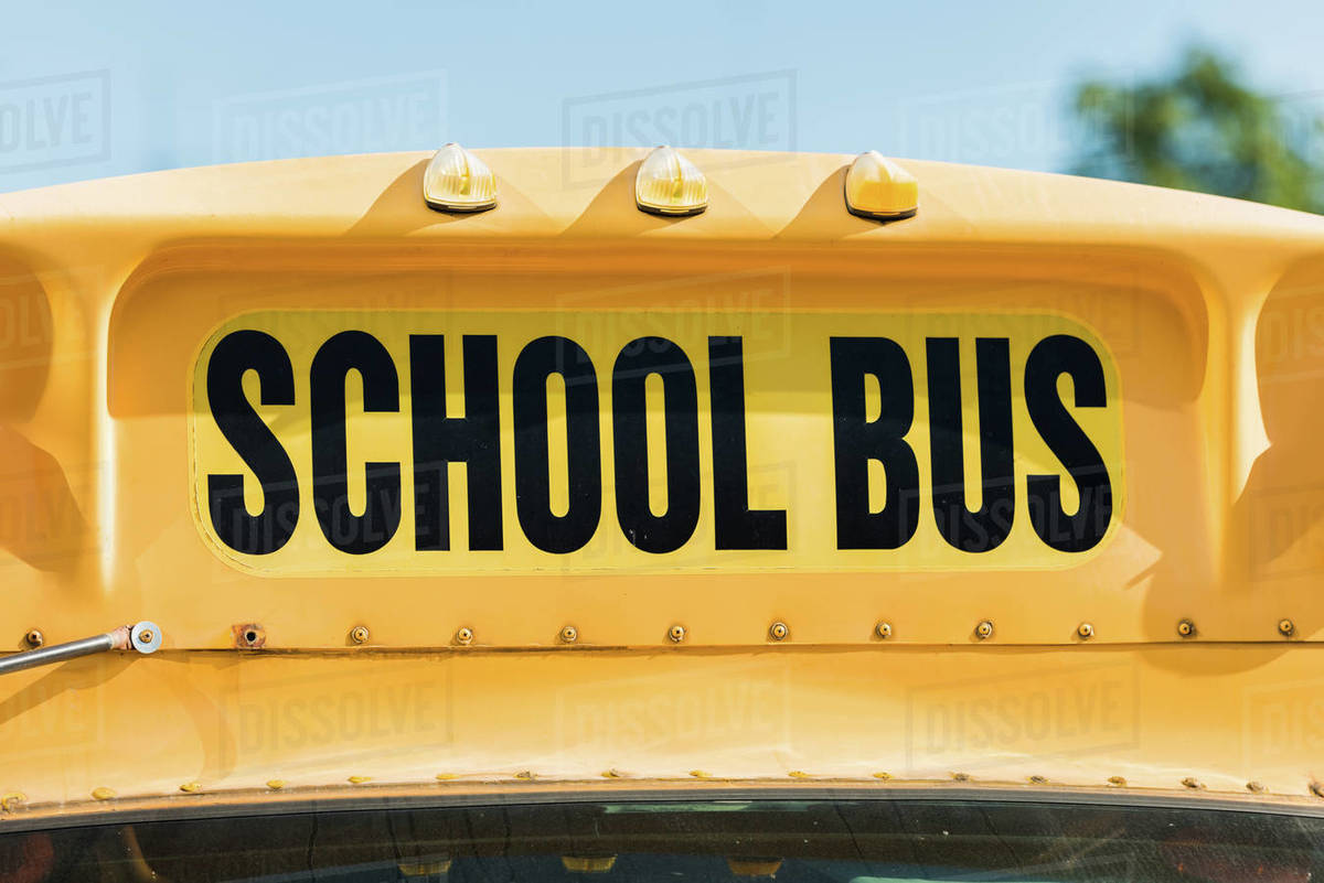 close-up shot of school bus inscription over front window of bus ...