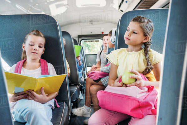 group of pupils riding on school bus during school excursion - Royalty ...