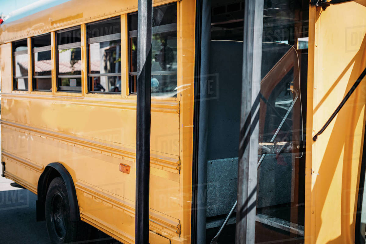 partial view of opened empty school bus parked on street - Royalty-free ...